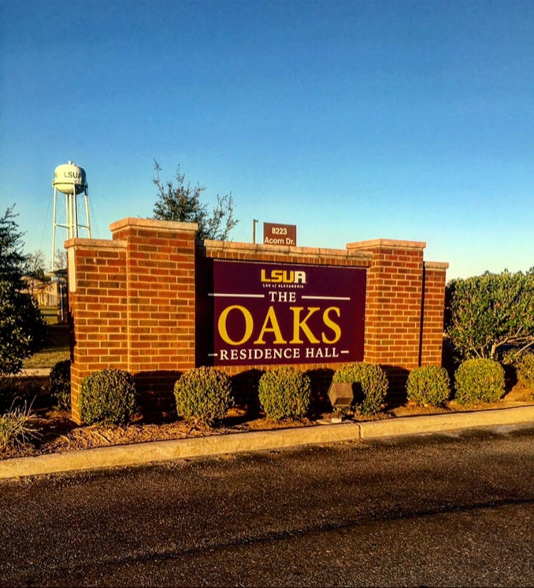 A beautiful welcoming sign located in front of The Oaks office with the ...