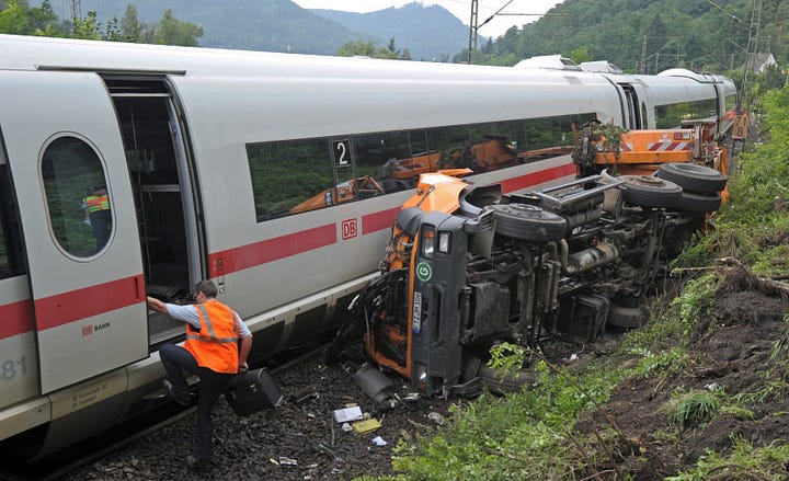 Aftermath of a trash truck falling onto train tracks and getting ...