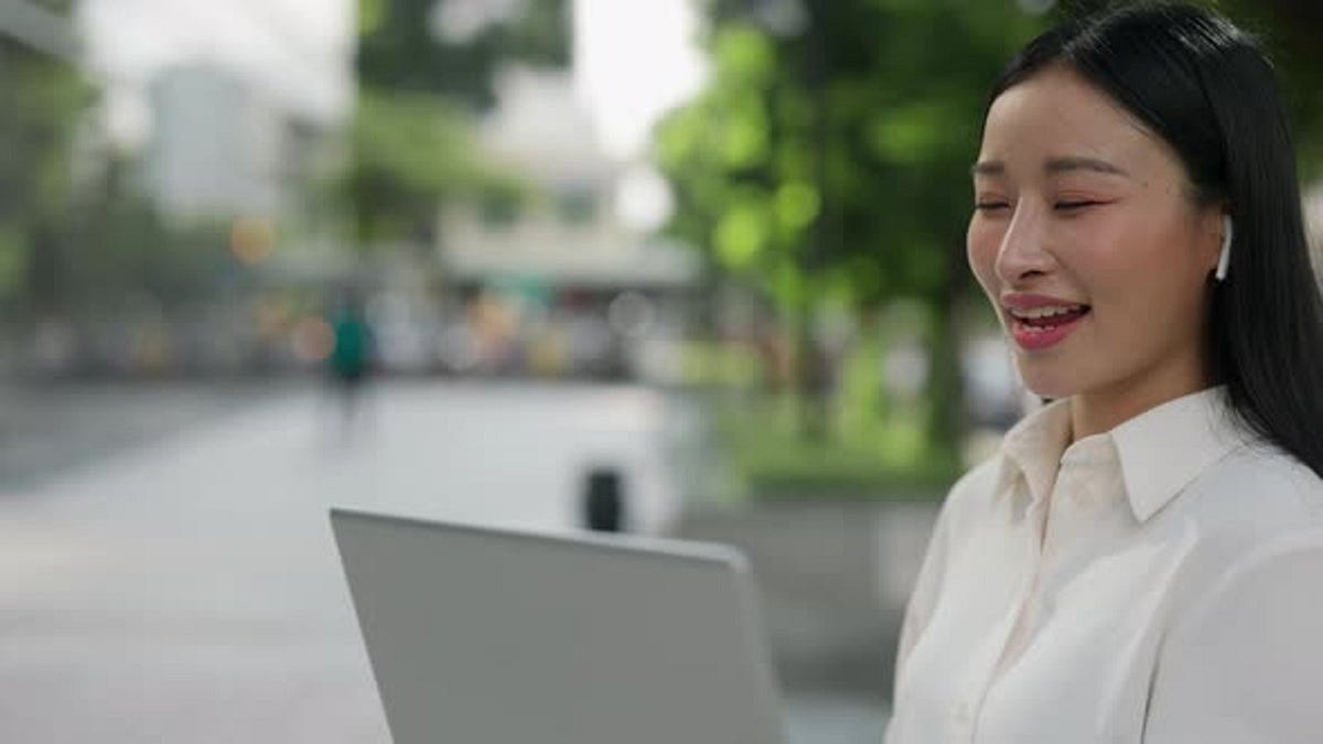 Side View of the Attractive Girl Talking Using the Laptop Greeting Her ...