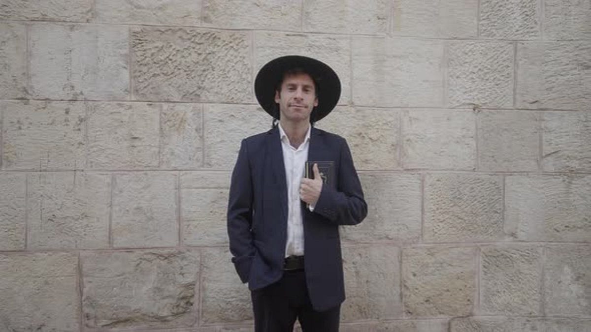 Orthodox Jewish male standing in front of stone wall - Cyvbng - Medium