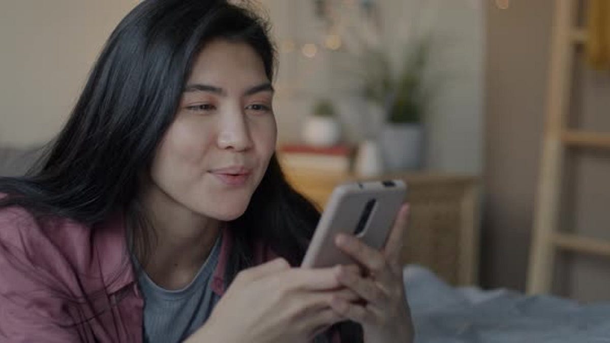 Pretty Asian Lady Messaging with Smartphone Touching Screen Lying in ...