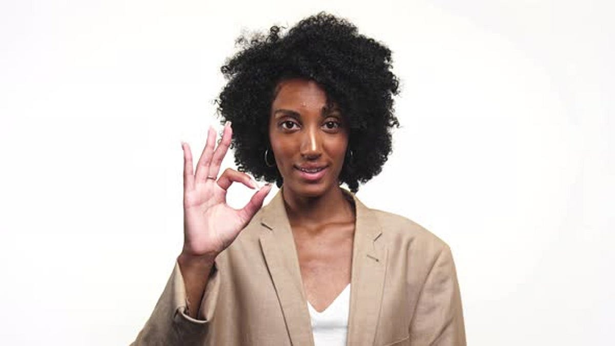 Woman Making OK Hand Gesture on White Background - Lumenlorekeeper - Medium