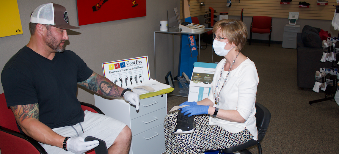 Good Feet Store co-owner Beth Schneider does a fitting for a customer ...