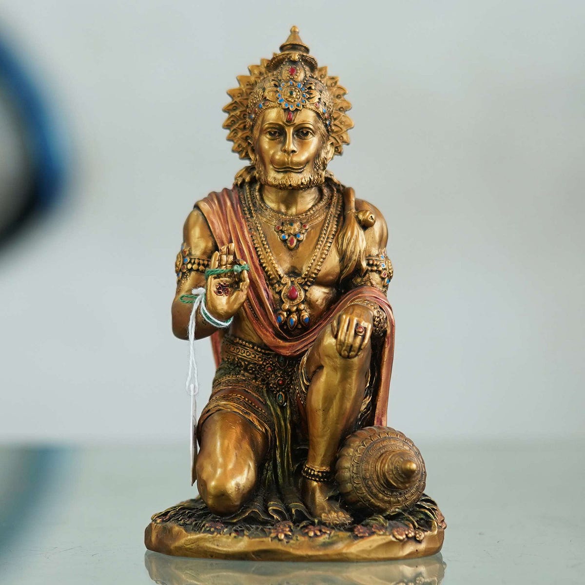 LORD HANUMAN A small statue depicting the Hindu deity Hanuman, sitting ...