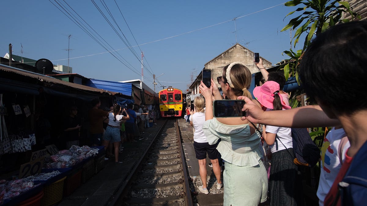 Train Zooms Through Busy Market, Tourists Snap Perfect Shots - The ...
