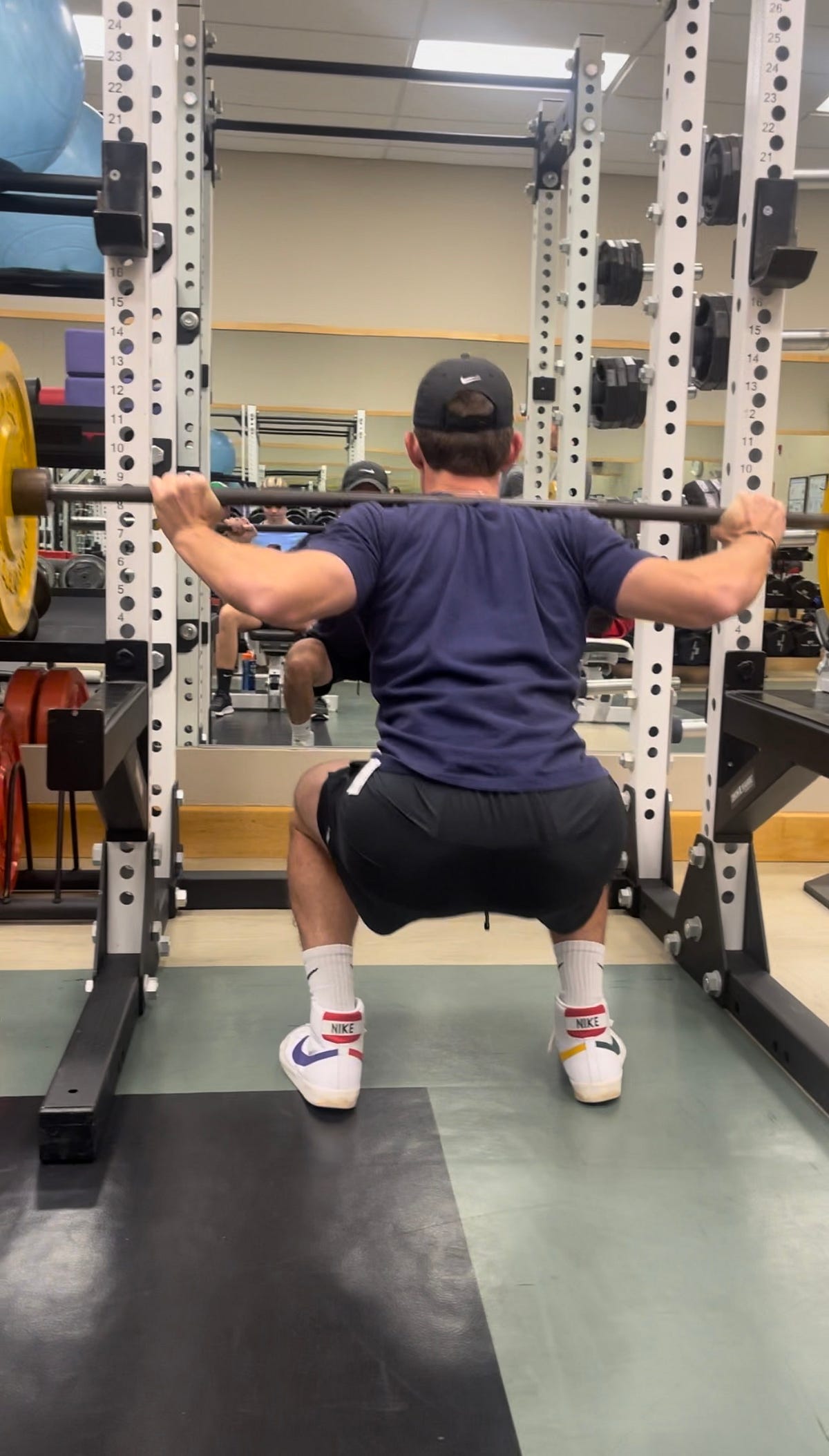 Man squatting with great focus and form. - Lauren Hawk - Medium