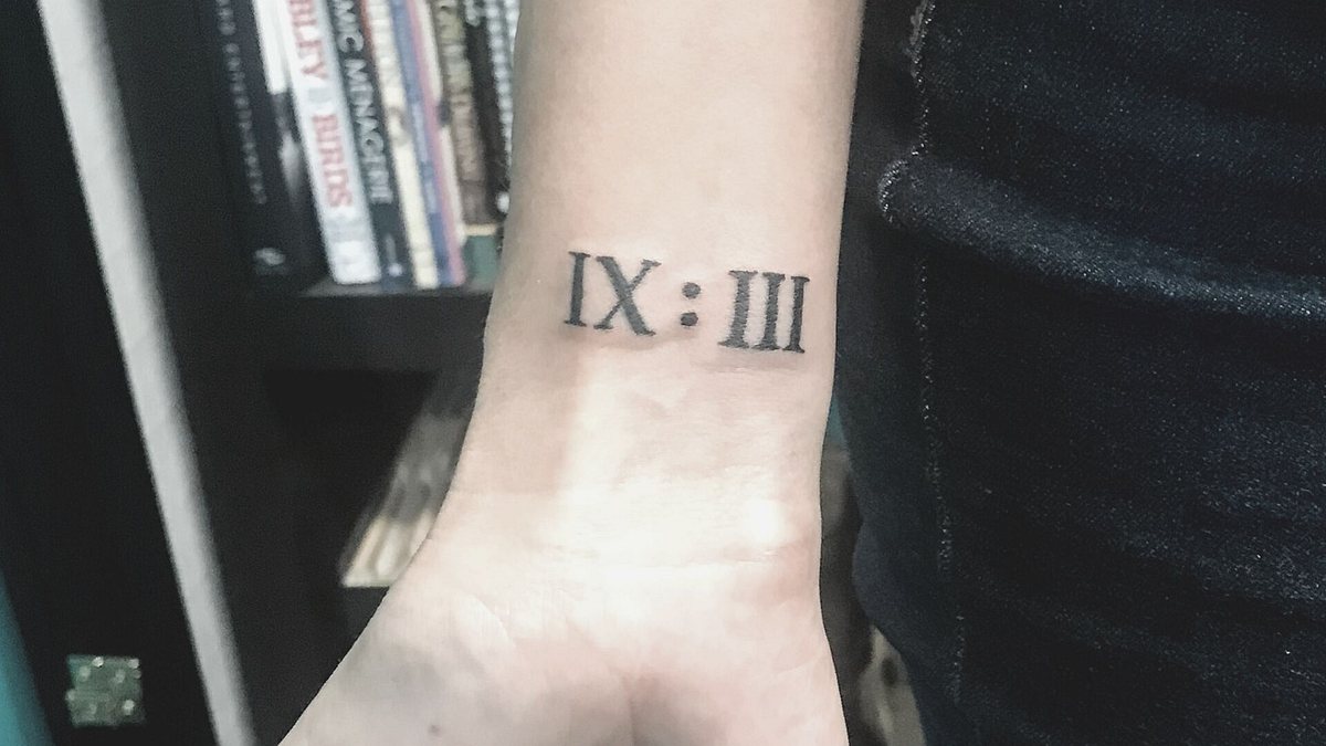 Roman Numerals Tattoo On Ribs