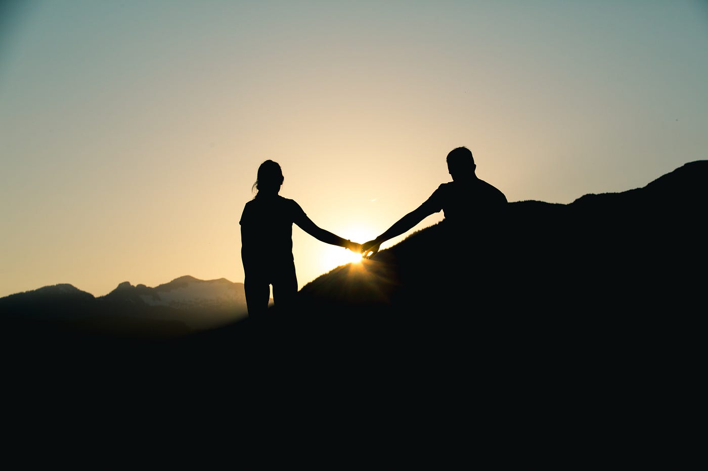 Two People Reaching For Each Other
