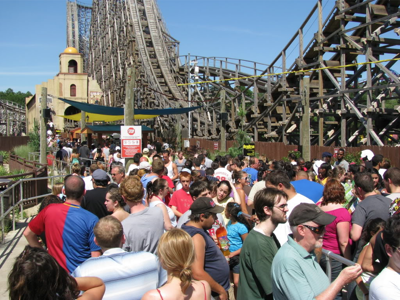 Long Line Of People At Amusement Park