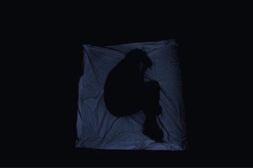 Alone in the quiet, where shadows fall, She hides her tears, behind the ...