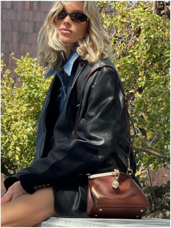 Elevate your look by donning the Elsa Hosk Biker Black Leather Long ...
