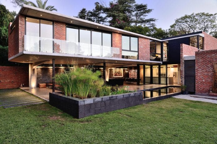 House Sher by Eftychis Architects: concrete and facebrick walls with a ...