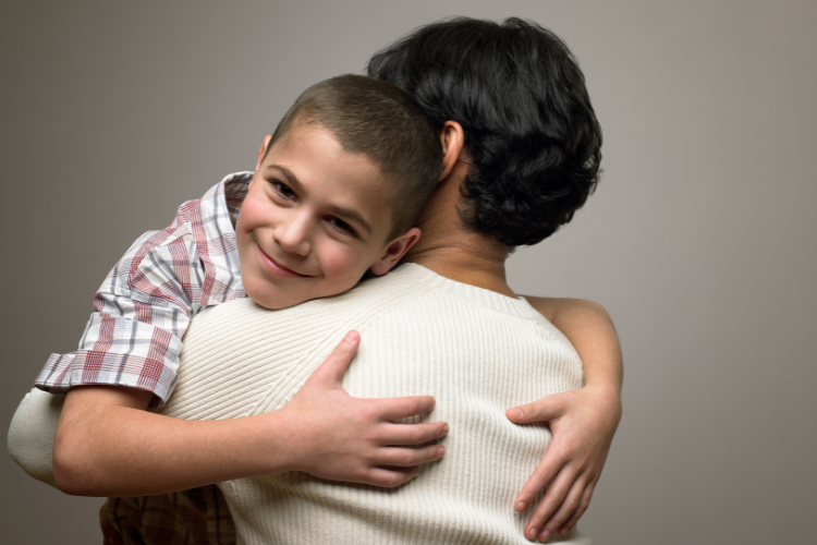 Father And Teenage Son Hugging