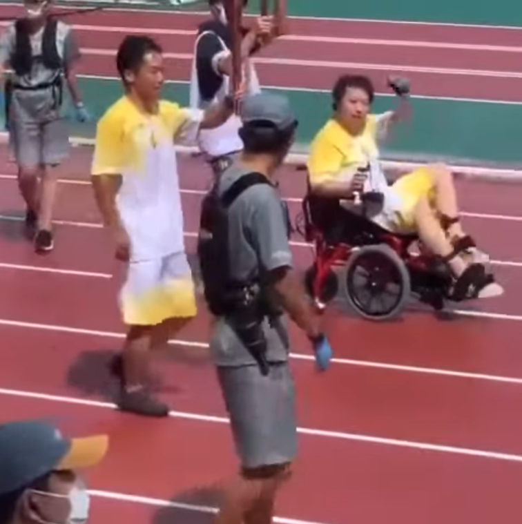 Junpei-Sano, the Torchbearer, in a COGY Pedal Wheelchair - Timmermans ...