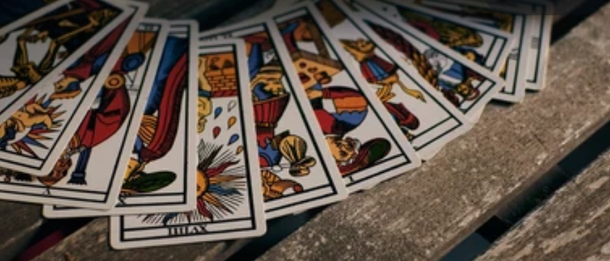 Culling my Collection(s). “Tarot cards on a wooden table.”… | by Earth ...