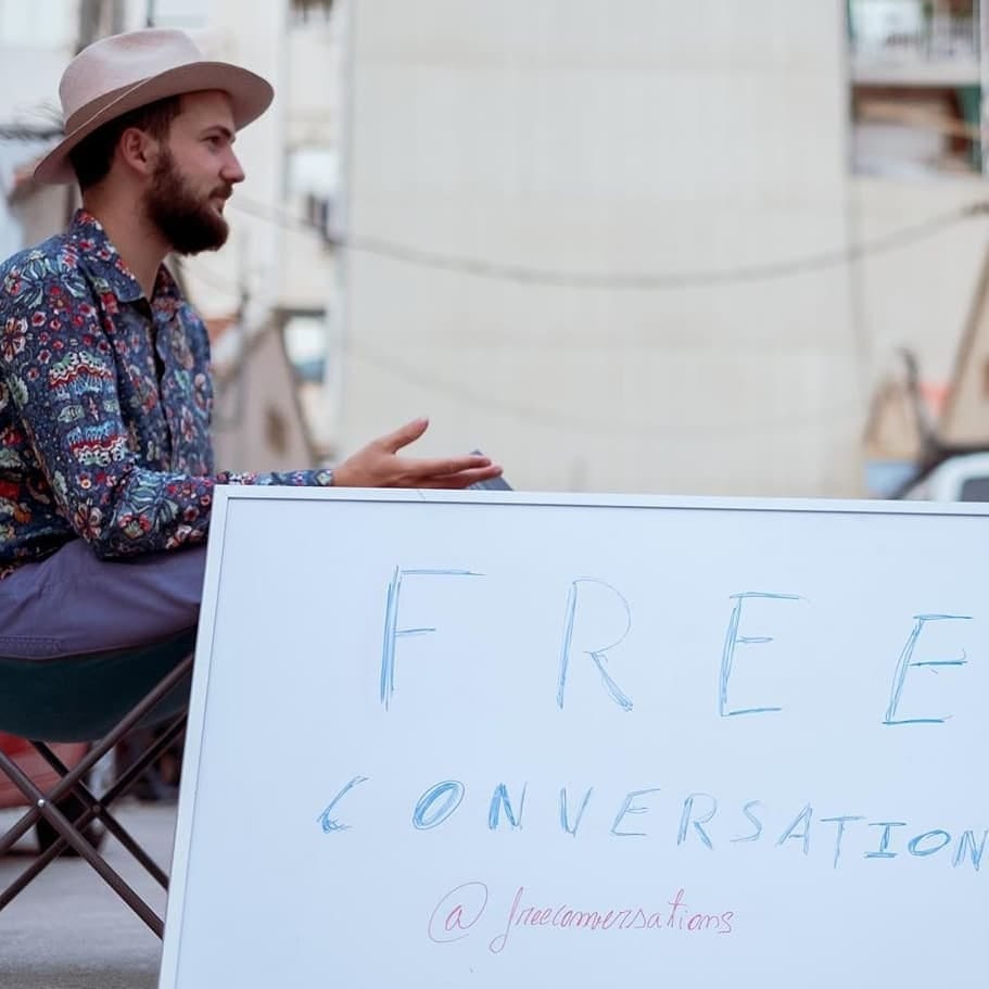 The Free Conversations Movement. Two chairs in a city centre and a sign ...